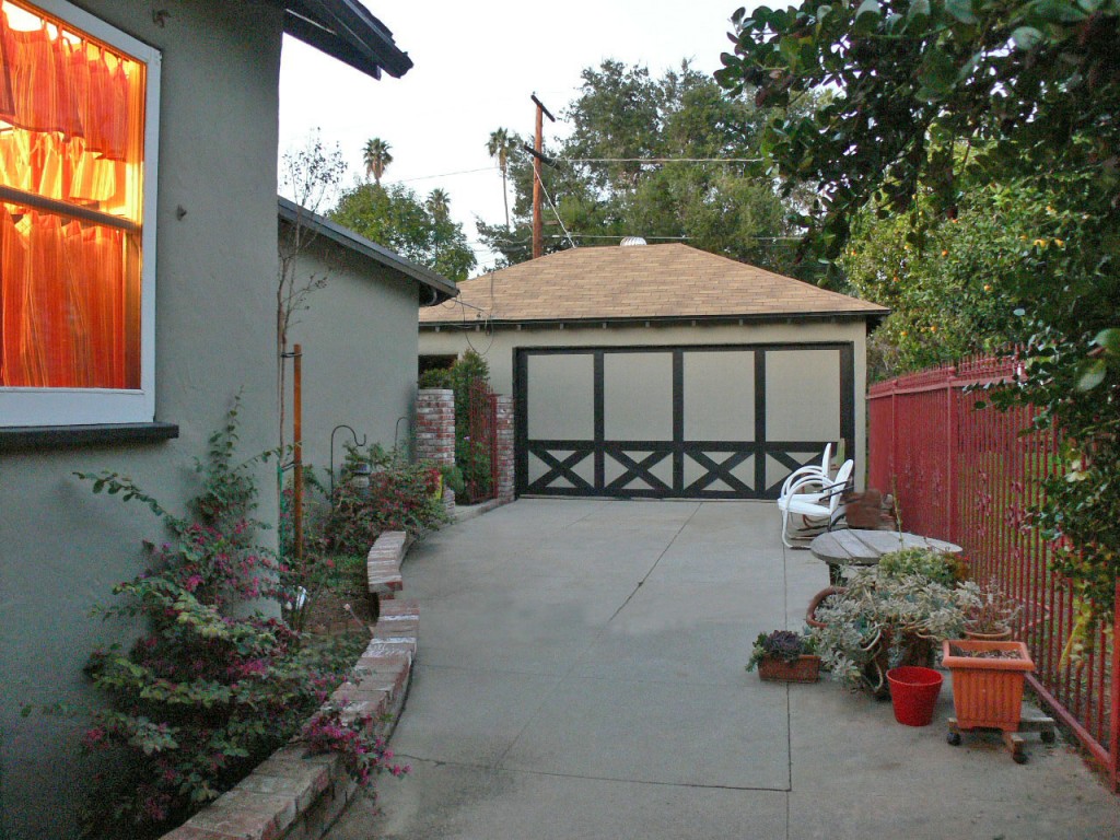 Detached 2-car garage with wrought iron gated driveway long enough to ...